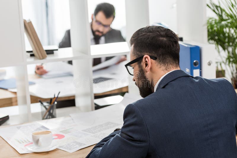 Businessmen Sitting at Working Tables with Shelves Stock Image - Image ...