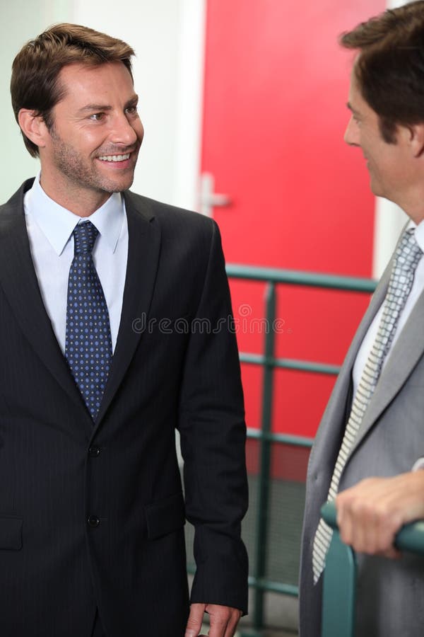 Businessmen talking stock image. Image of front, hair - 24731811