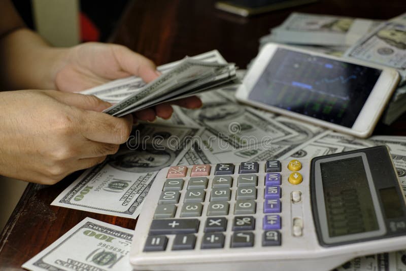 Businessmen Counting Money on a Stack of 100 US Dollars Banknotes Stock ...