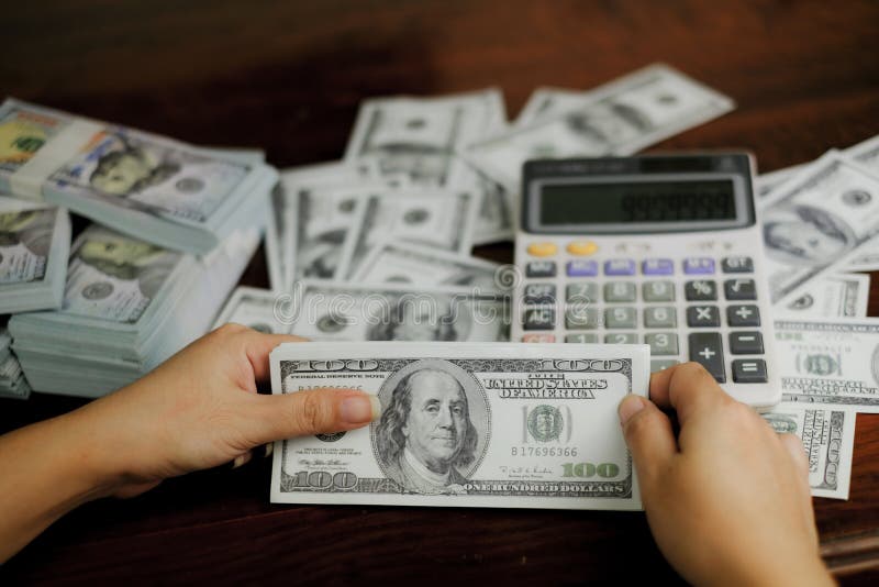 Women Counting Money on a Stack of 100 US Dollars Banknotes Stock Image ...