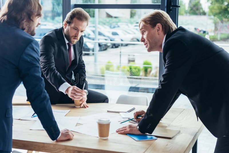 Three Confident Professional Businessmen Working with Papers Stock ...