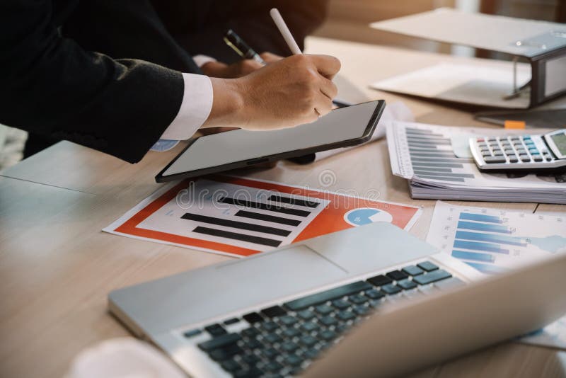 Businessmen Write Project Ideas and Use Laptops To Edit Papers for ...