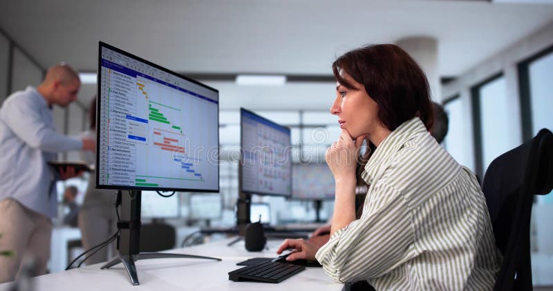 Businesspeople Analyzing Gantt Chart and Calendar on Computer Stock ...