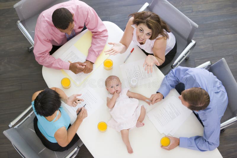 Businesspeople in Boardroom with a Baby on Table Stock Image - Image of ...