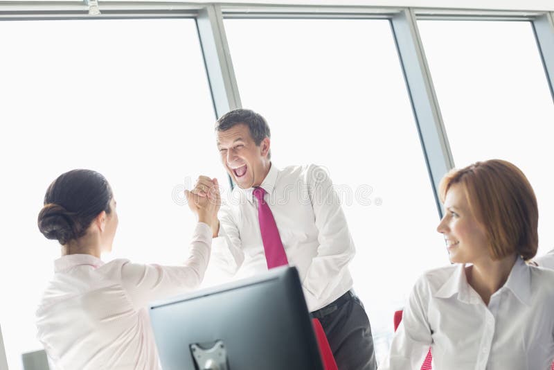 Businesspeople Celebrating Success in Office Stock Image - Image of ...