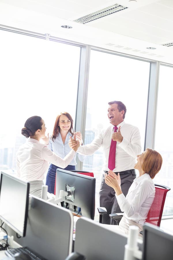 Businesspeople Celebrating Success in Office Stock Photo - Image of ...