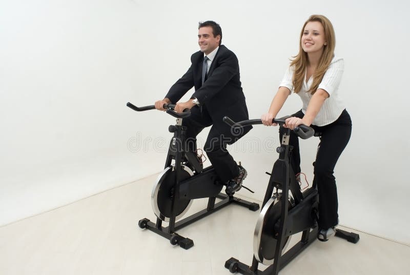Businesspeople on Exercise Bikes - Horizontal Stock Photo - Image of ...