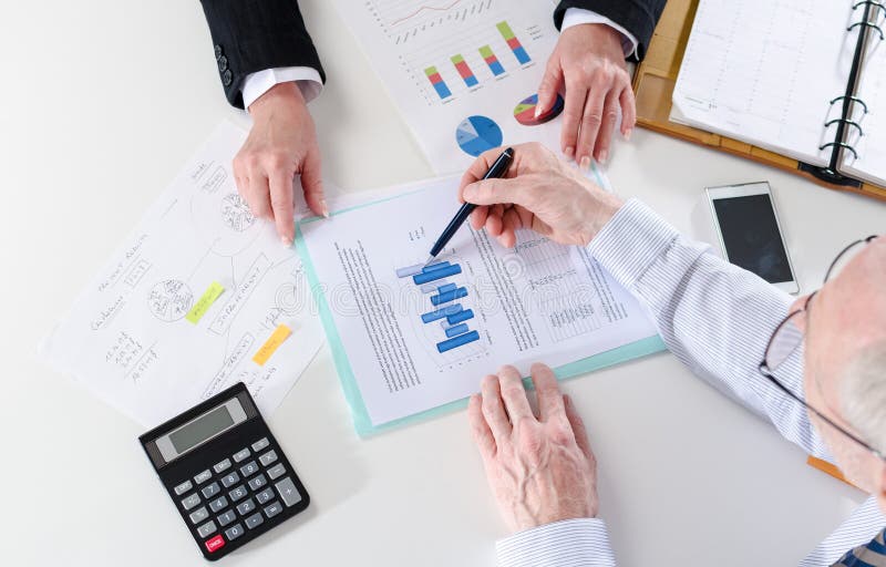 Businesspeople Having a Discussion about Financial Report Stock Image ...