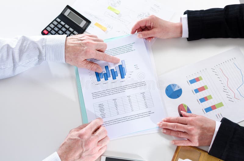 Businesspeople Having a Discussion about Financial Report Stock Photo ...