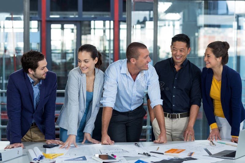 Businesspeople Having Discussion Over Document Stock Image - Image of ...