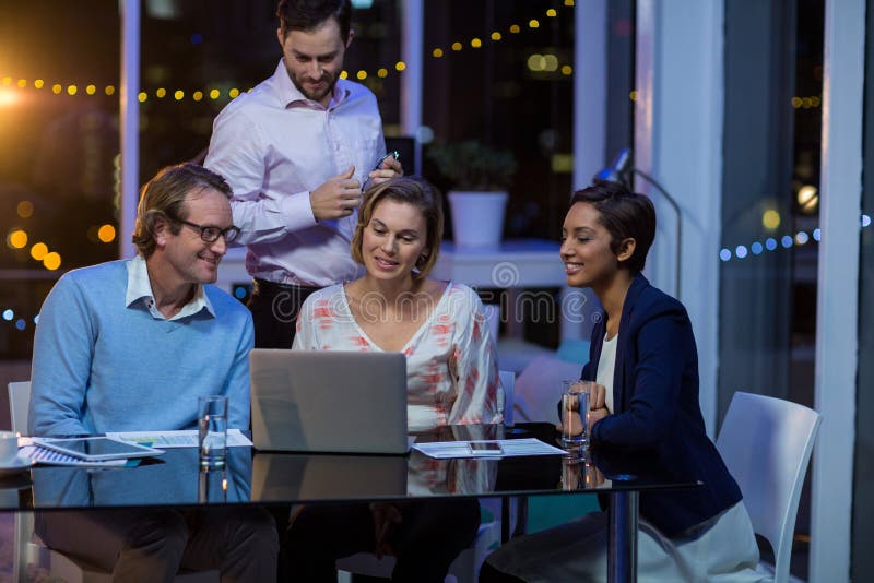 Businesspeople Having Discussion Over Laptop Stock Image - Image of ...