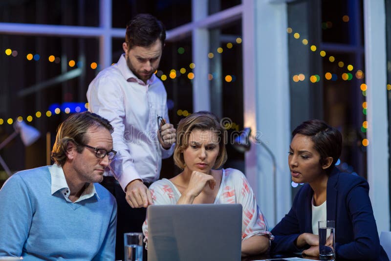 Businesspeople Having Discussion Over Laptop Stock Image - Image of ...