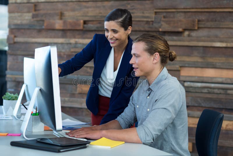 Businesspeople Having Discussion Over Personal Computer Stock Photo ...