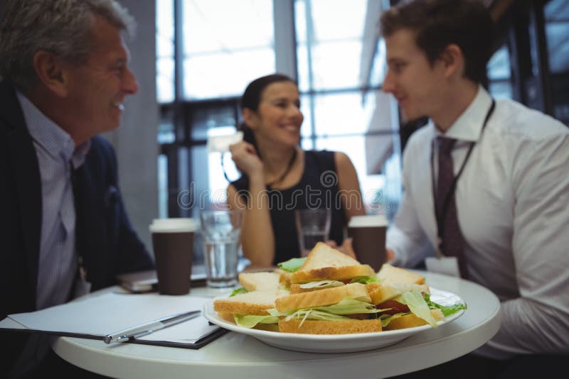 Businesspeople Interacting while Having Breakfast Stock Image - Image ...