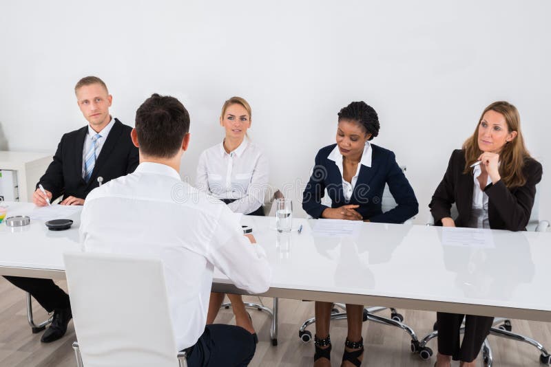 Businesspeople Interviewing Man Stock Photo - Image of glass ...