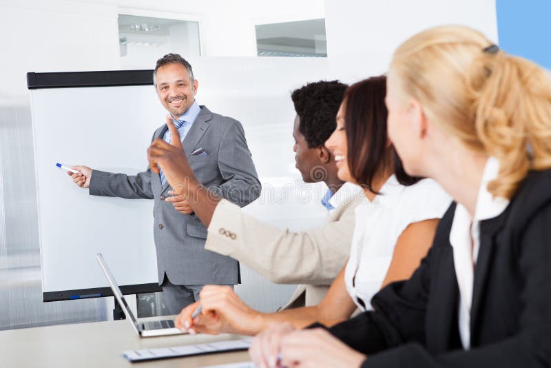 Businesspeople Looking at Man Explaining Stock Photo - Image of ethnic ...