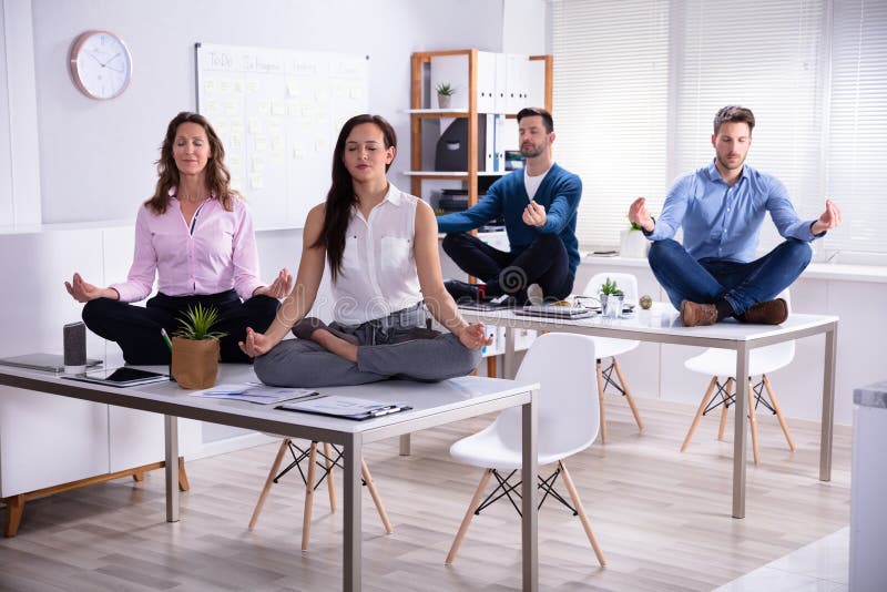Businesspeople Meditating in Office Stock Photo - Image of active ...