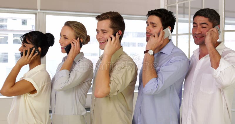 Businesspeople Phoning while Standing in a Row Stock Footage - Video of ...