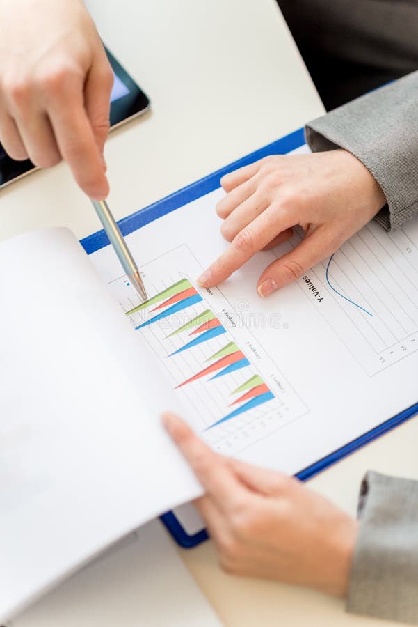 Businesspeople Pointing at the Graph on Document Stock Photo - Image of ...