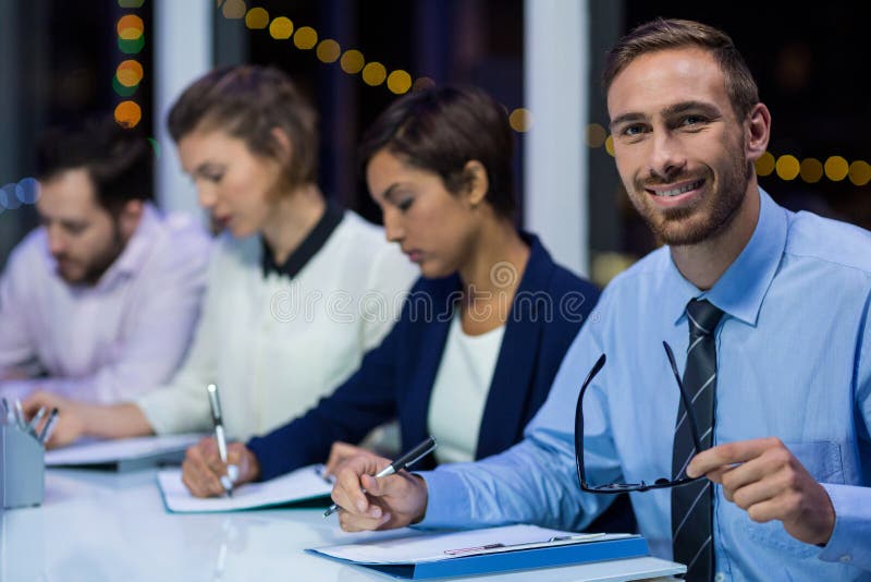 Businesspeople Preparing Document in Office Stock Photo - Image of ...