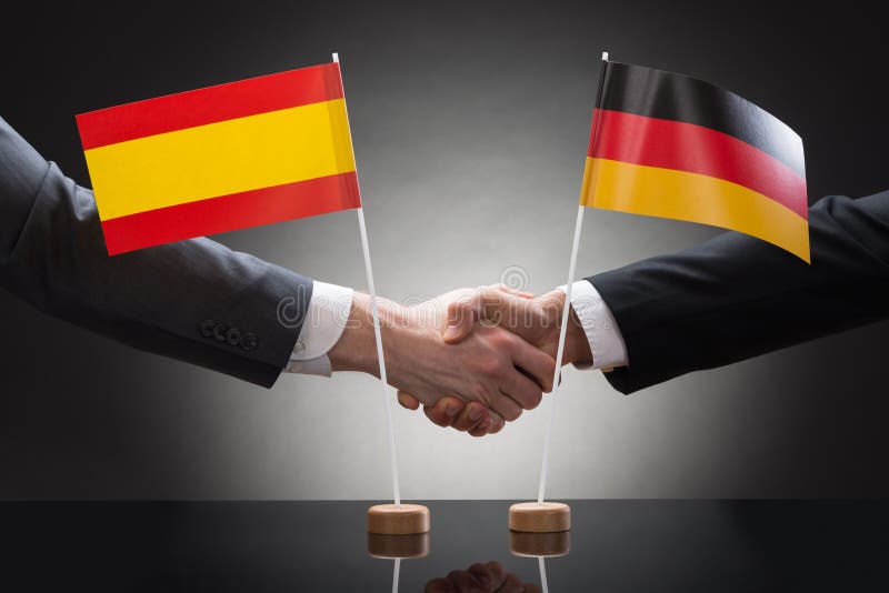 Businesspeople Shaking Hands with Spain and Germany Flags Stock Image ...