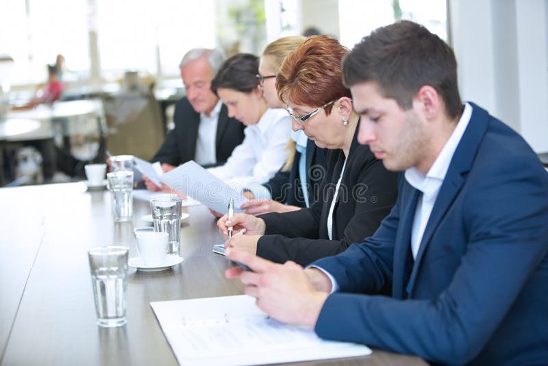 Businesspeople Sit at Table in Conference Room Stock Image - Image of ...