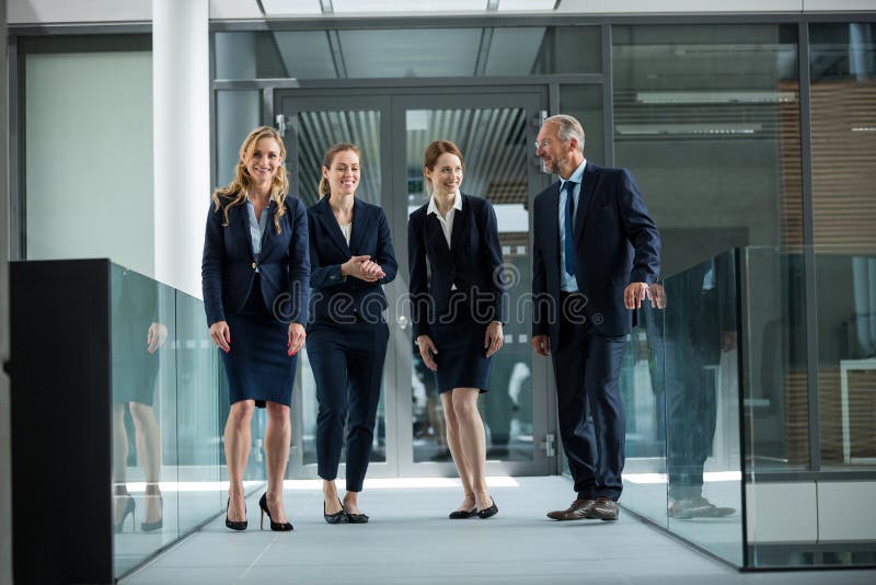 Businesspeople Standing and Having a Discussion in Office Stock Image ...