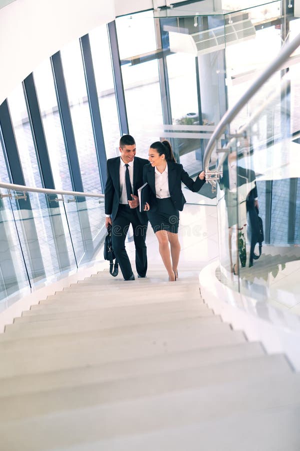 Businesspeople Talking As they Walk into the Office Stock Photo - Image ...
