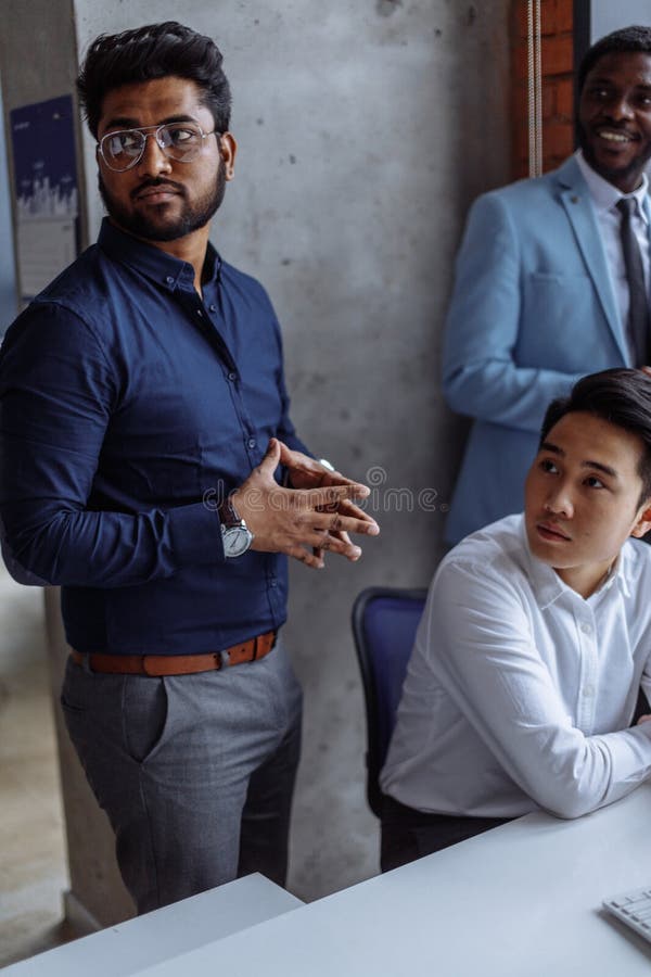 Group Focused Male Business People Gathered Around Computer in Office ...
