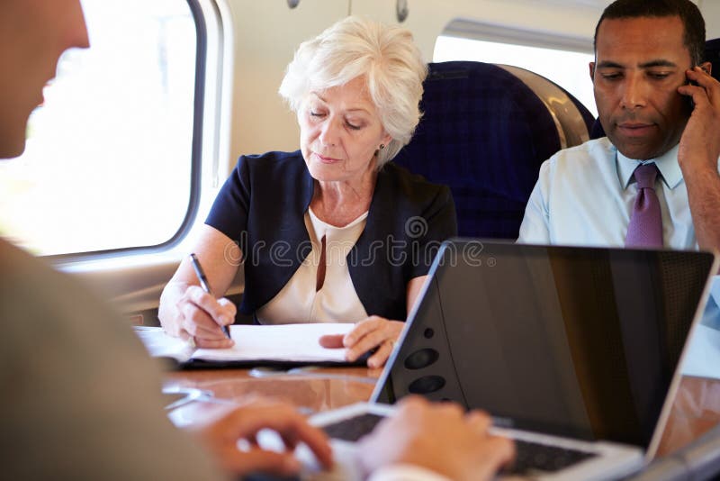 Businesswoman Commuting To Work on Train and Using Laptop Stock Image ...