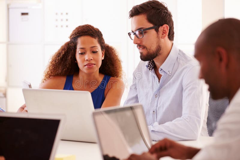 Businesspeople Using Laptop in Office of Start Up Business Stock Image ...