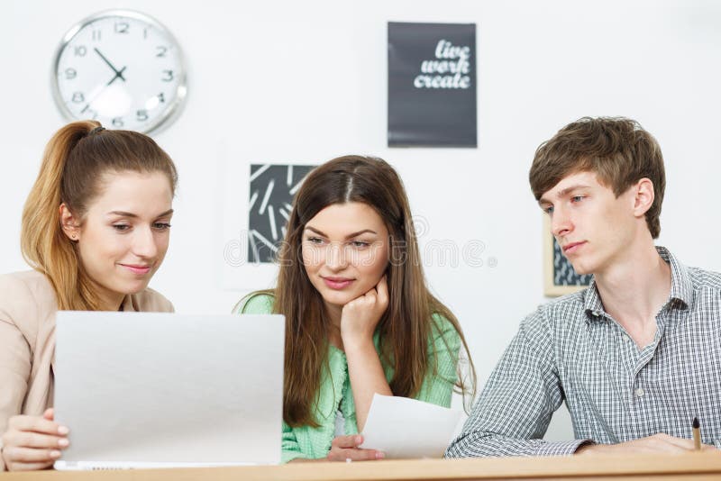 Businesspeople Watching Something on Laptop Stock Image - Image of ...