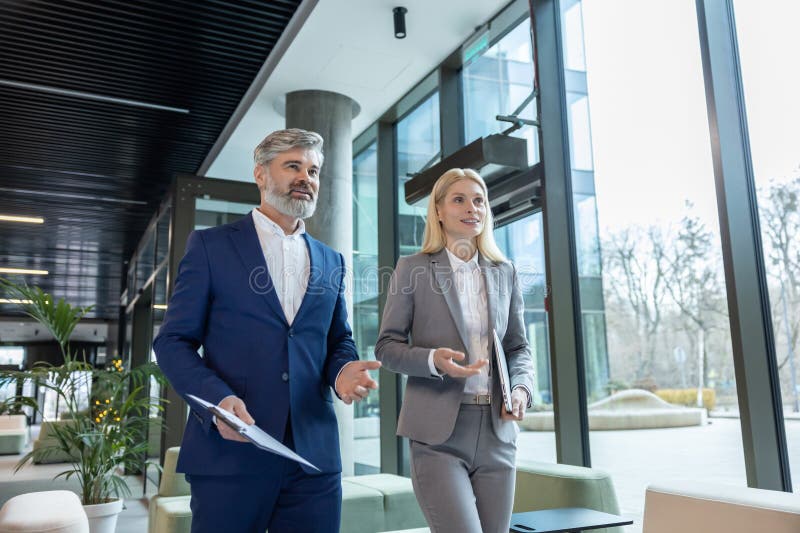 Businesspeople Wearing Suits Walking Together Smiling while Talking ...