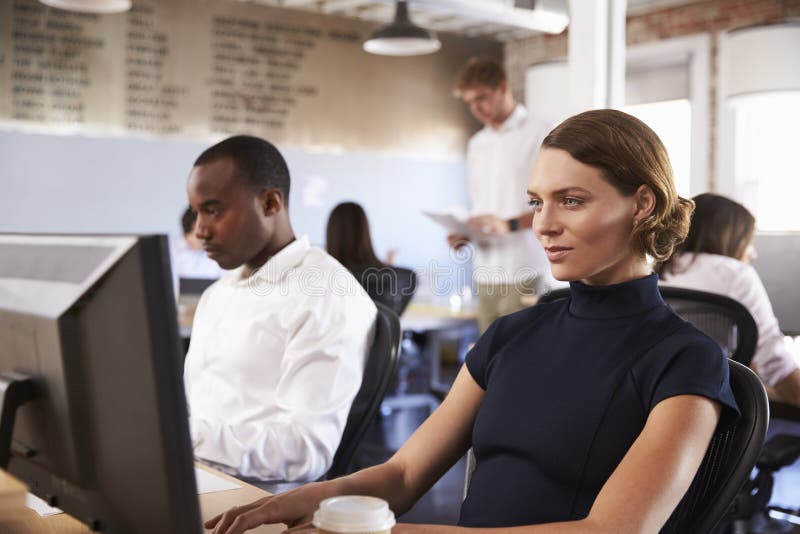 Businesspeople Working at Computers in Busy Modern Office Stock Image ...