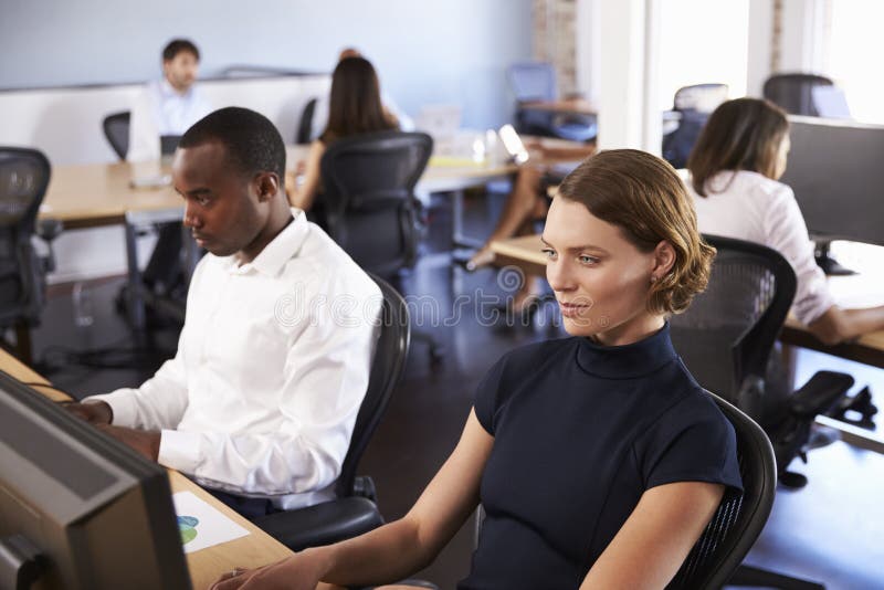 Businesspeople Working at Computers in Busy Modern Office Stock Image ...
