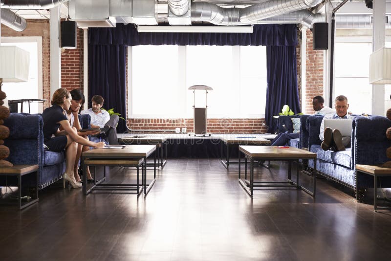 Businesspeople Working in Relaxation Area of Modern Office Stock Photo ...