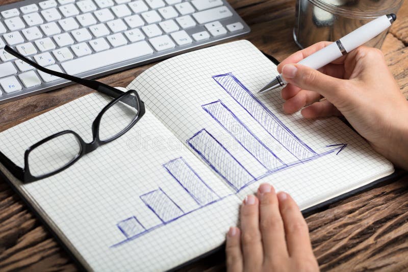 Businessperson Drawing Graph on Notebook Stock Image - Image of ...