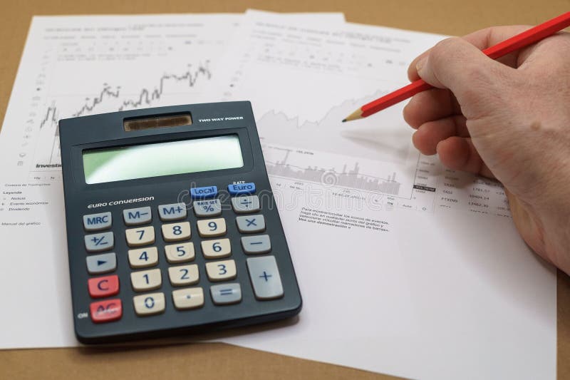 Someone Writes on Top of a Pile of Papers with a Calculator Stock Image ...