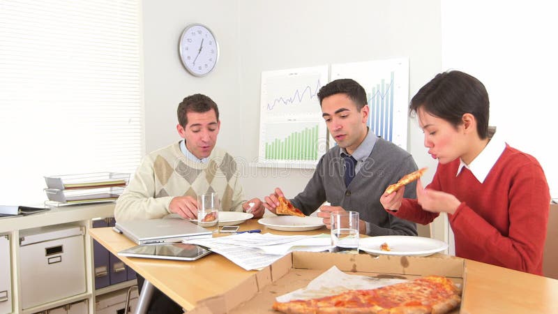 Businessteam Eating Pizza while at Work Stock Video - Video of computer ...