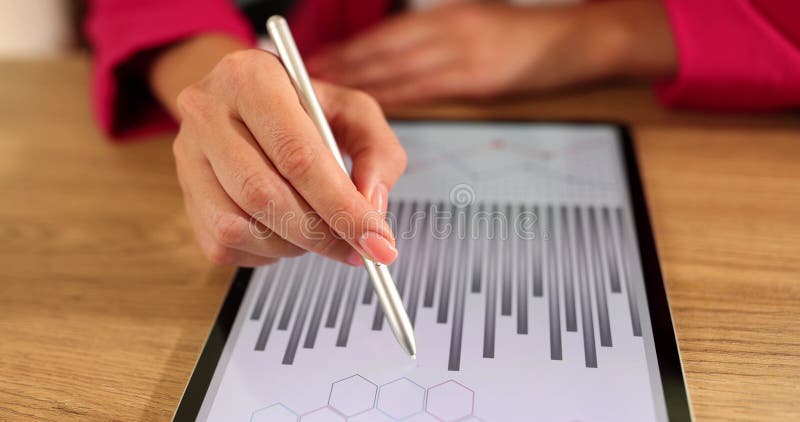 Businesswoman Analyzing Financial Statistics Displayed on Tablet Screen ... Businesswoman Analyzing Financial Statistics Displayed on Tablet Screen ...