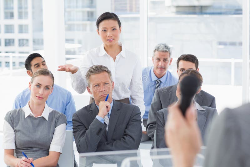 Businesswoman Asking Question during Meeting Stock Image - Image of ...