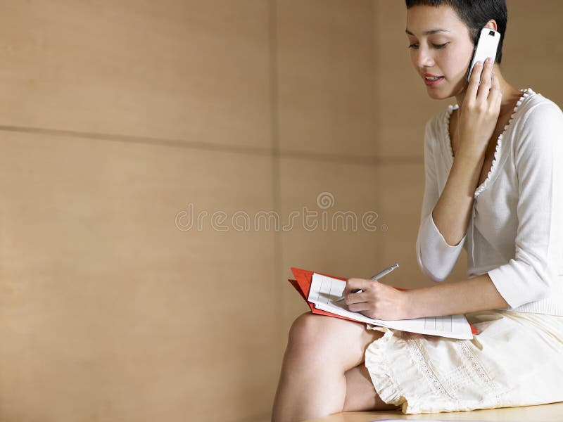 Businesswoman on Call Taking Notes Stock Image - Image of preparing ...