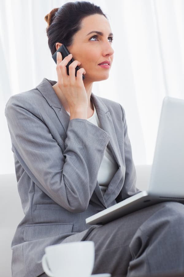 Businesswoman Calling with Her Mobile Phone and Using Laptop Sit Stock ...