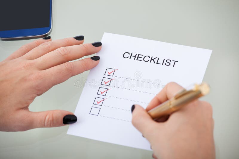 Businesswoman with Checklist at Desk Stock Photo - Image of ...