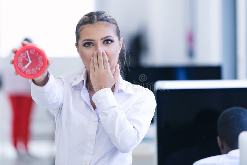 Businesswoman with Clock Being Late for Her Deliverables Stock Photo ...