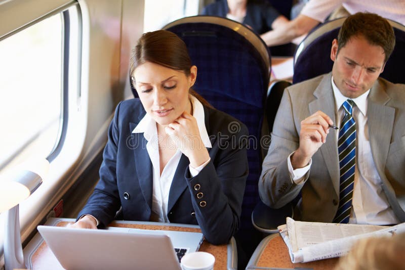 Businesswoman Commuting To Work on Train and Using Laptop Stock Image ...