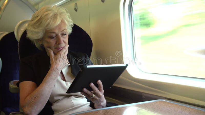 Businesswoman Commuting on Train Using Digital Tablet Stock Video ...