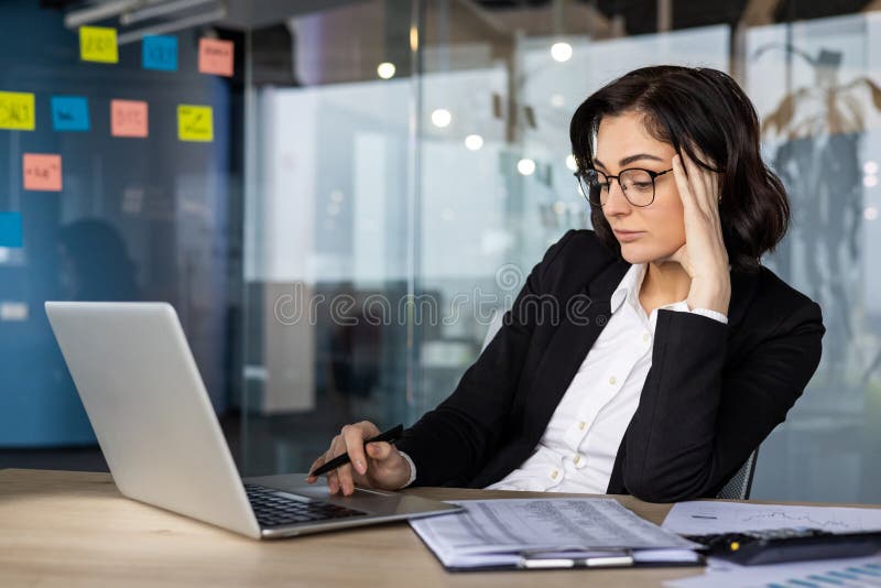 Focused Businesswoman Working at Office Desk Analyzing Data and Using ...