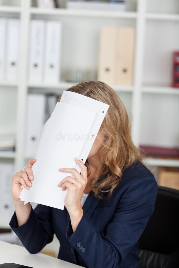 Businesswoman Covering Face with Documents at Desk Stock Image - Image ...