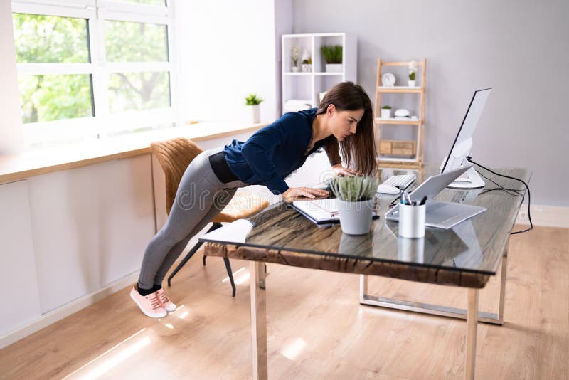 Businesswoman Doing Push Up on Office Desk Stock Photo - Image of floor ...
